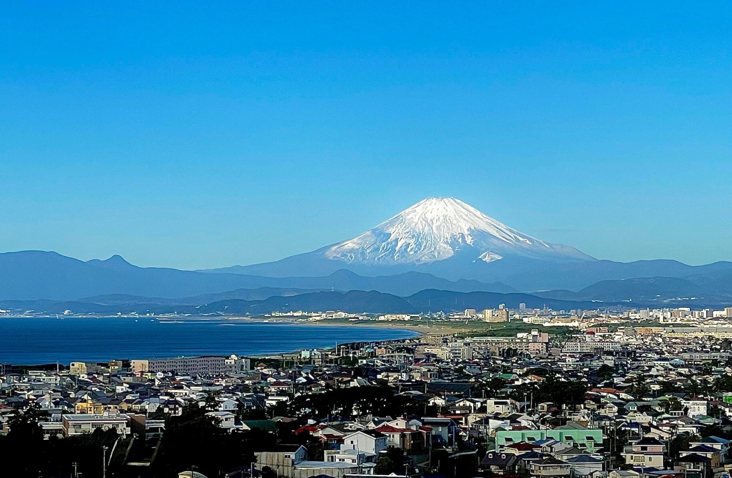 The majestic Mt. Fuji is snow-capped for the first time after a long ...