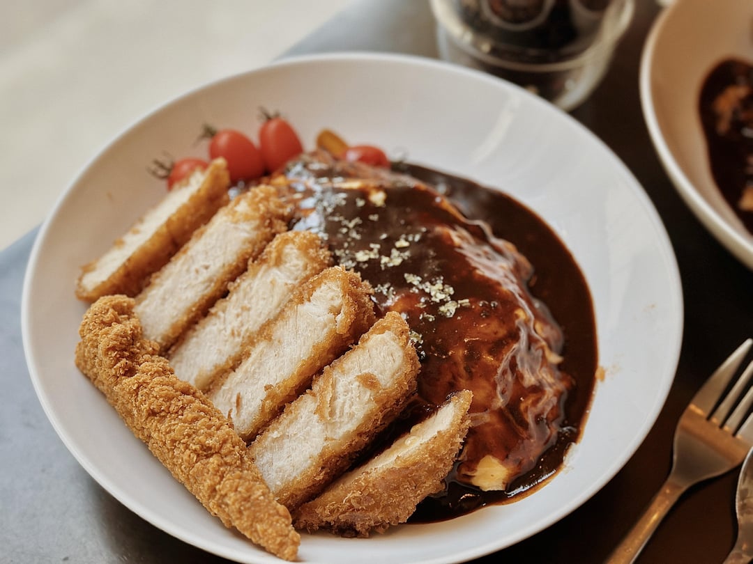 I made Japanese “omurice”. Slabs of roast pork katsu on a bed of ...