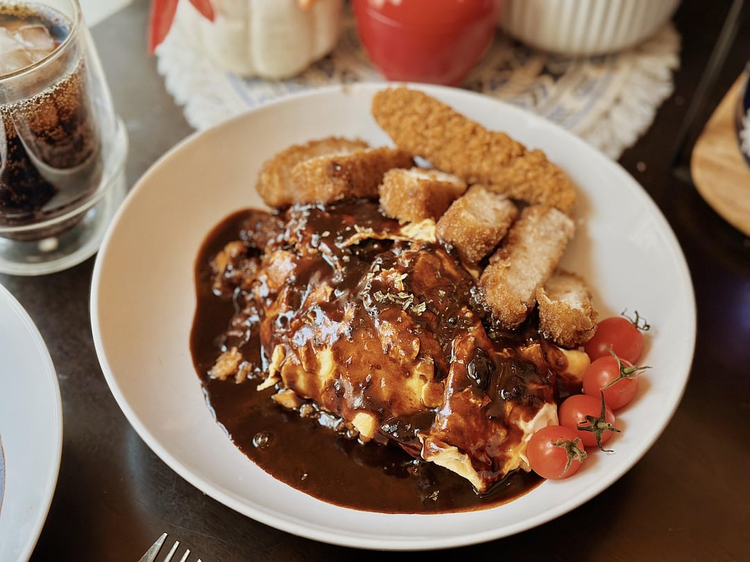 I made Japanese “omurice”. Slabs of roast pork katsu on a bed of ...